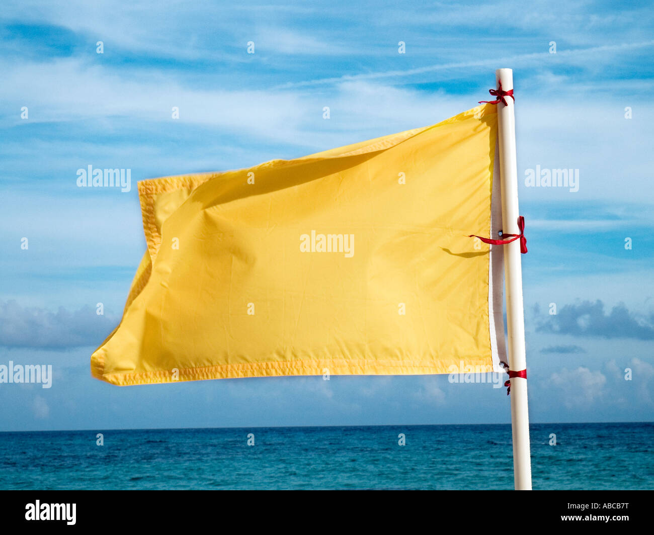 yellow flag on the sea meaning that swimming is dangerous Stock Photo ...