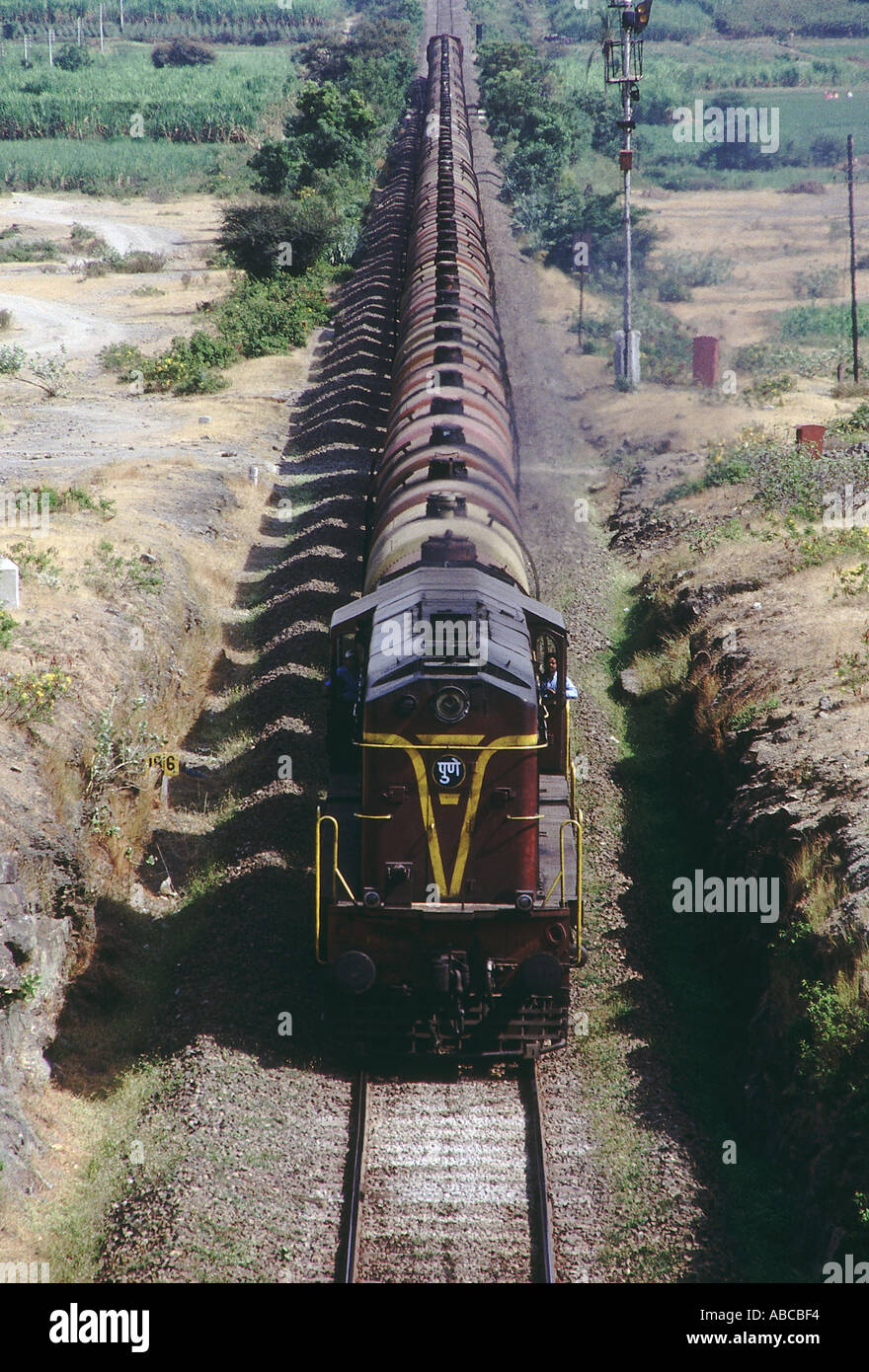 A train chugging along its tracks. India Stock Photo - Alamy