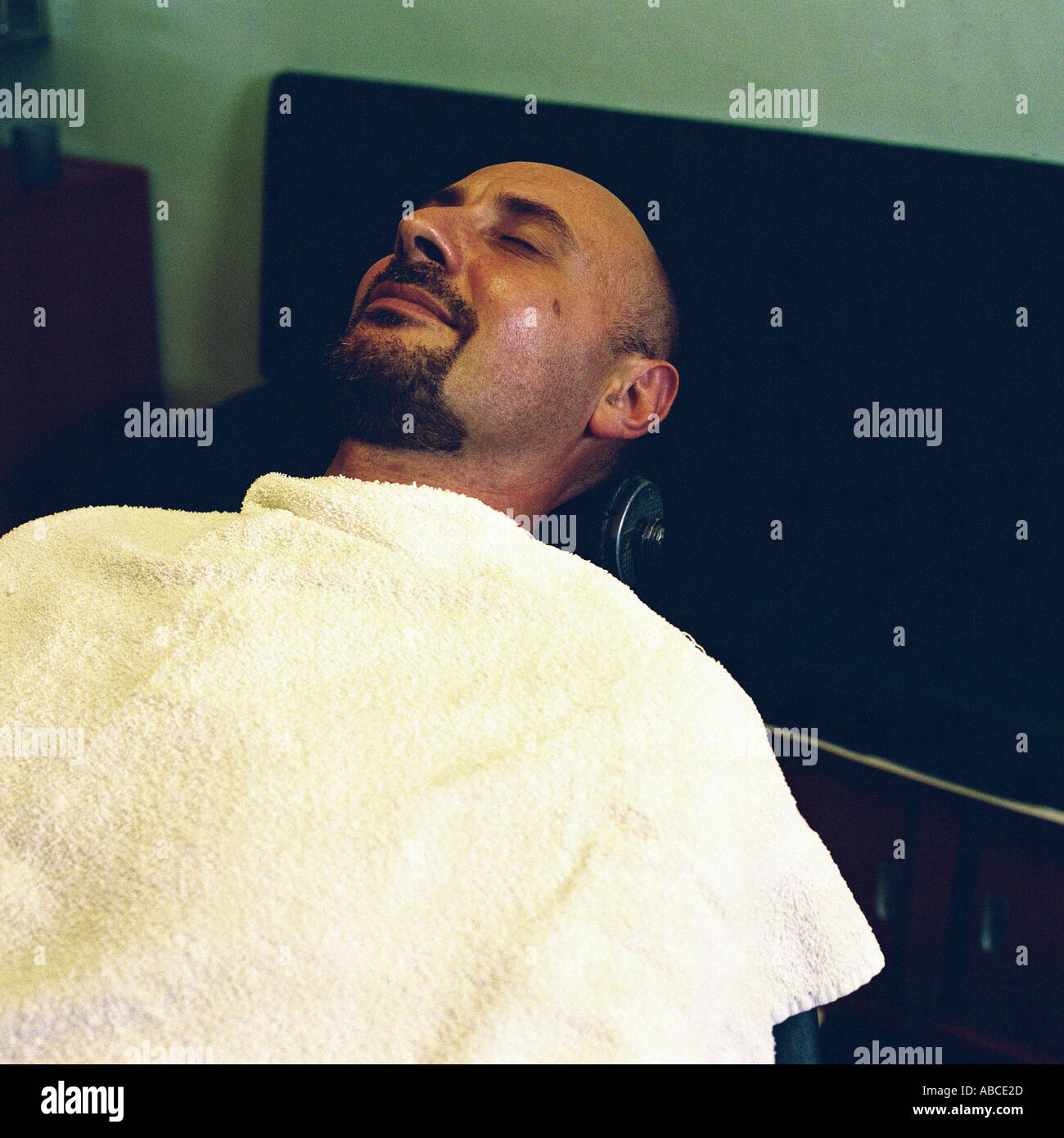 Man reclining at barbers Stock Photo - Alamy