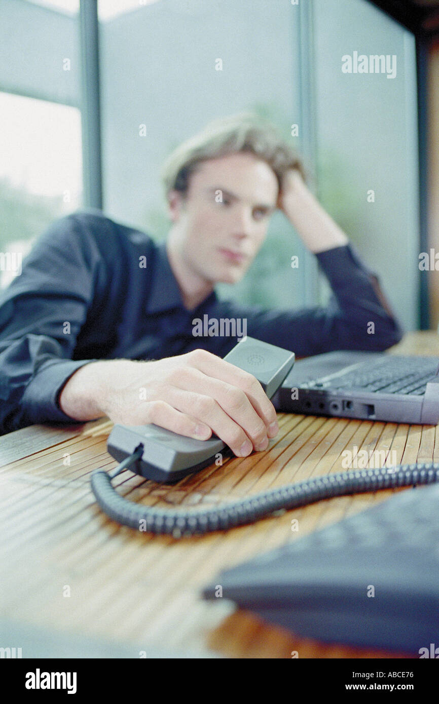 Man on laptop and telephone at home Stock Photo - Alamy