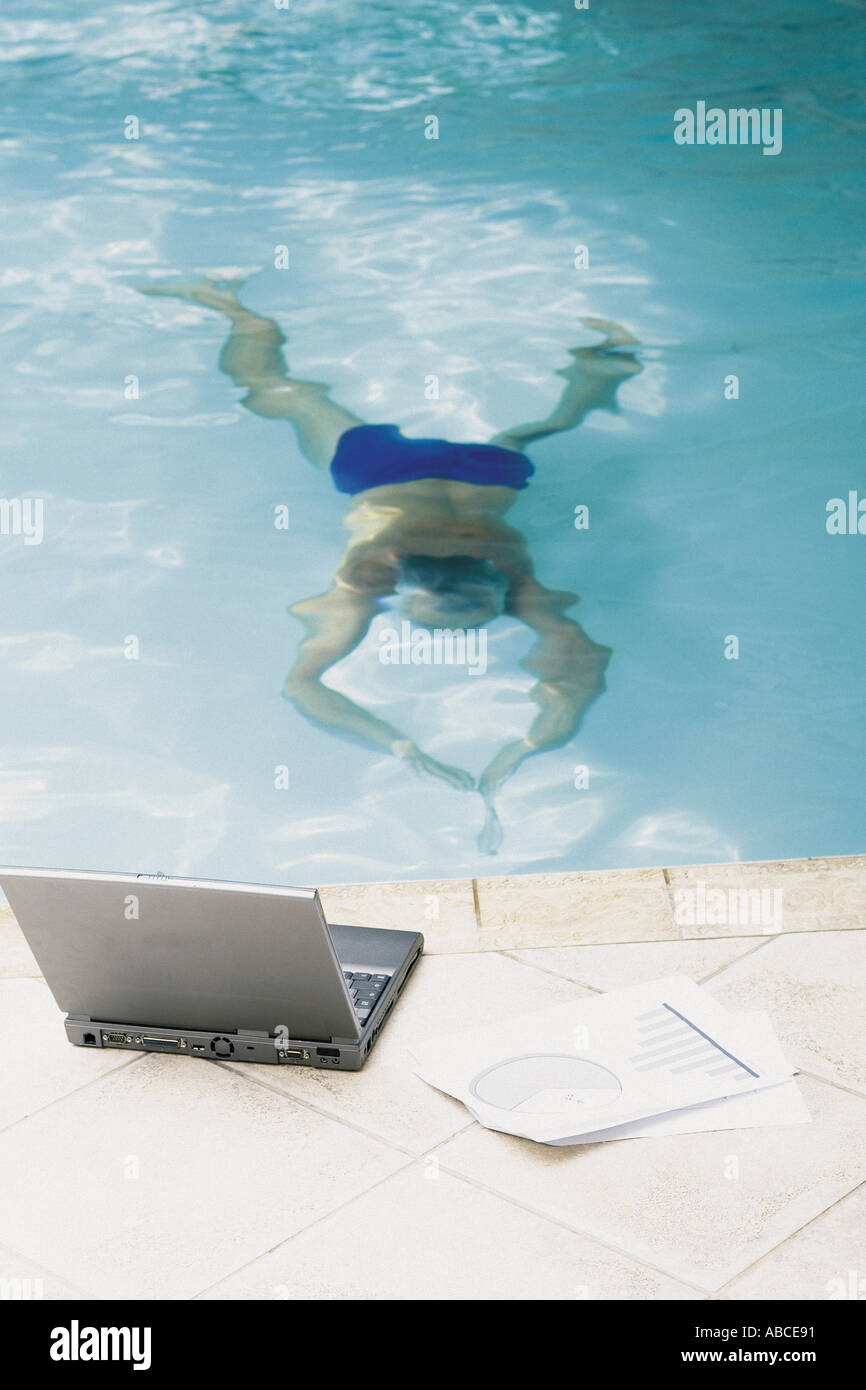 Man in swimming pool with computer Stock Photo - Alamy