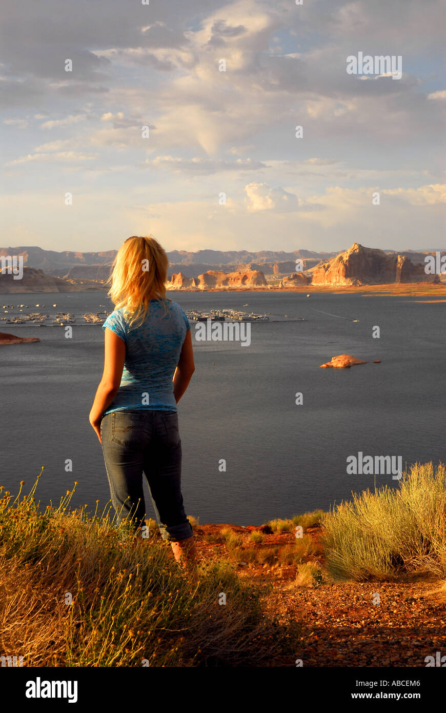 Arizona Lake Powell woman standing alone on cliff red desert mesa in ...