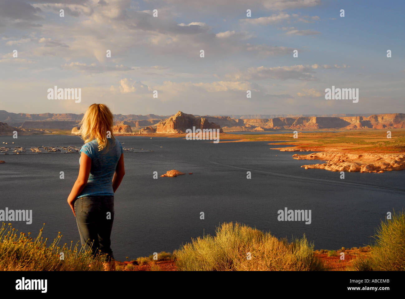 Arizona Lake Powell woman standing alone on cliff red desert mesa in ...