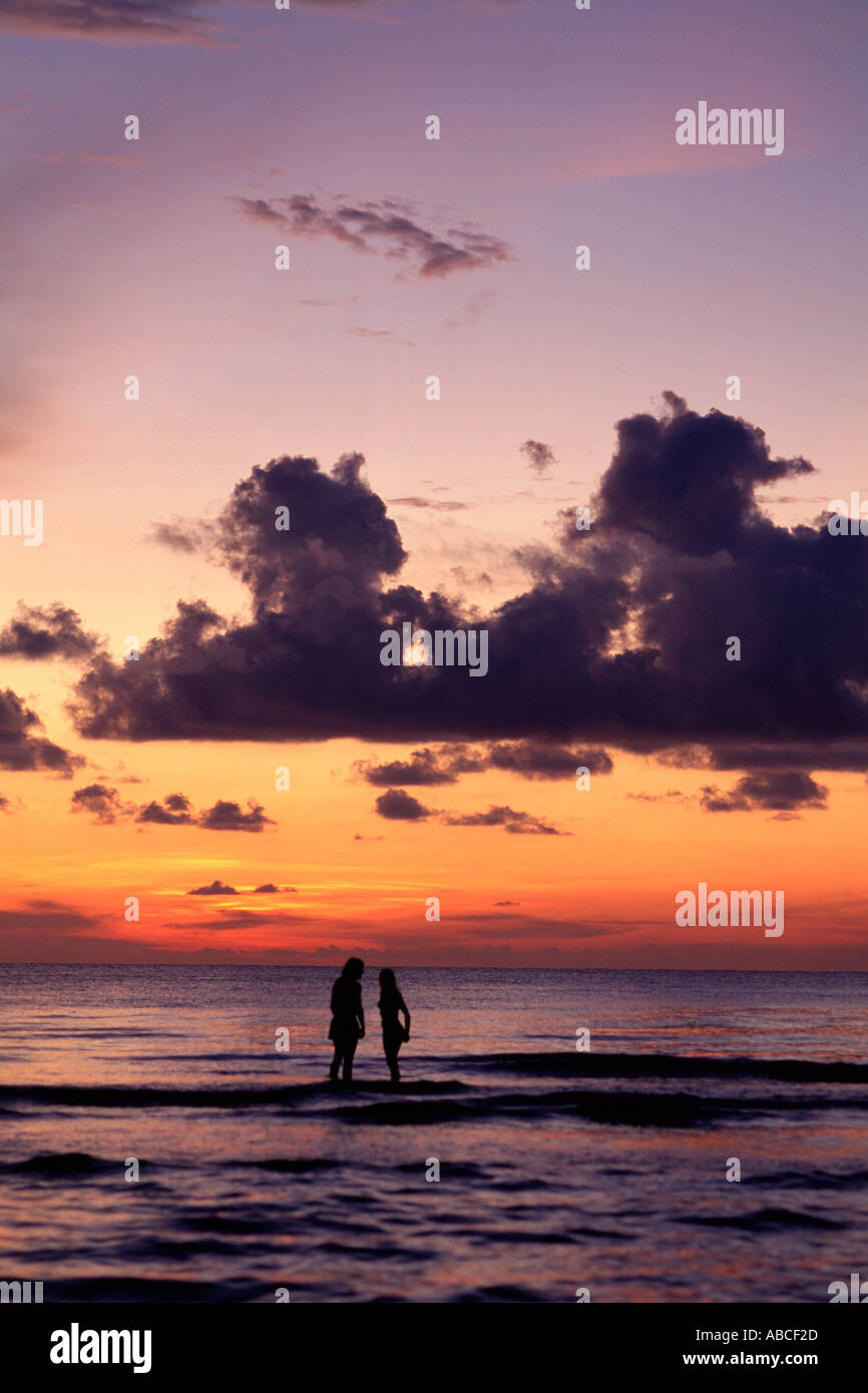 Couple in sea at sunset Stock Photo - Alamy