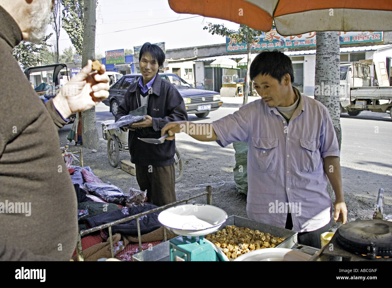 CHINA Beijing Street vendor cooking waffles and selling pieces by the ...