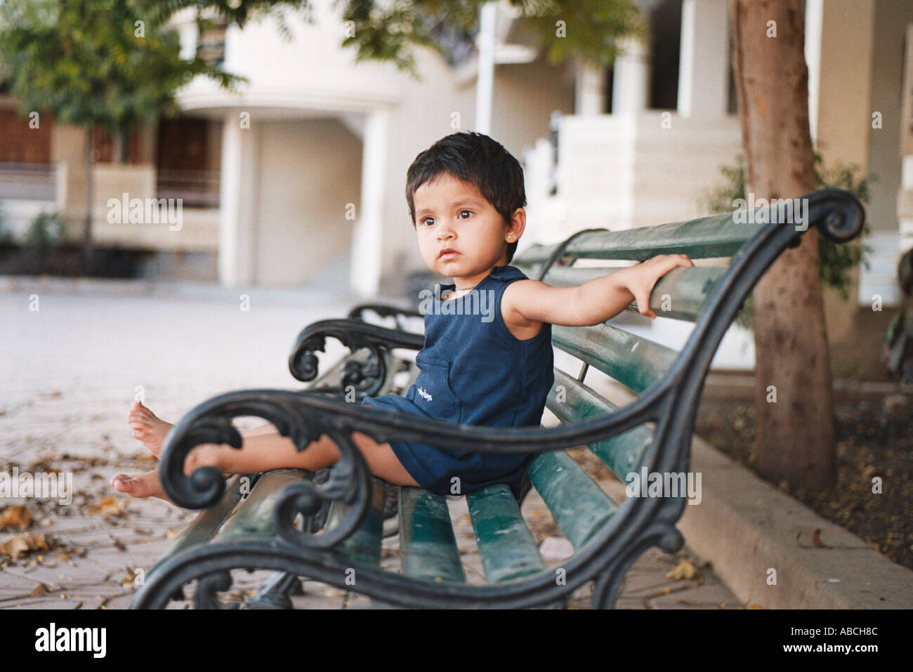 SSA70167 Young Indian Girl Esha sitting on a bench at park looking to ...