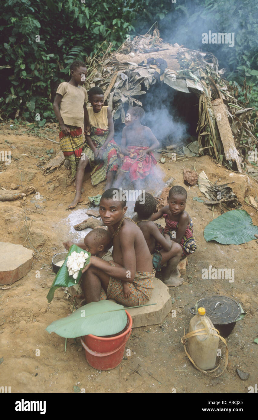 A Baka pygmy family by their temporary leaf houses in the rainforest of ...