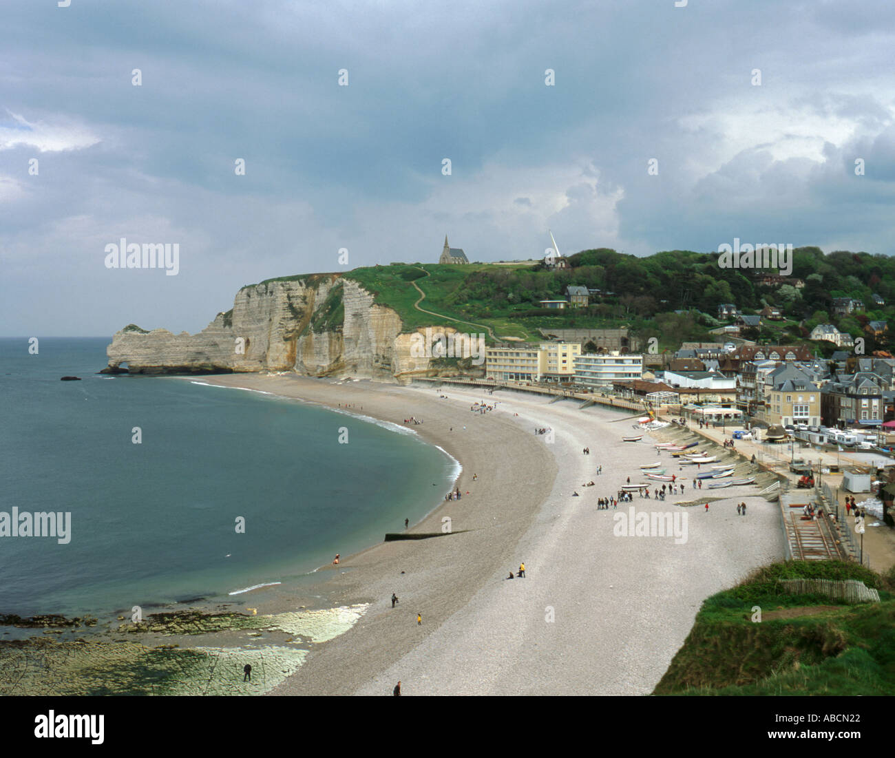 Beach and town of Étretat, with stony chalk cliffs of the Falaise d ...