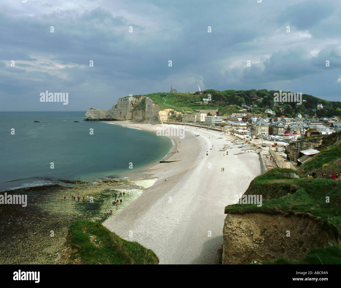 Beach and town of Étretat, with stony chalk cliffs of the Falaise d ...