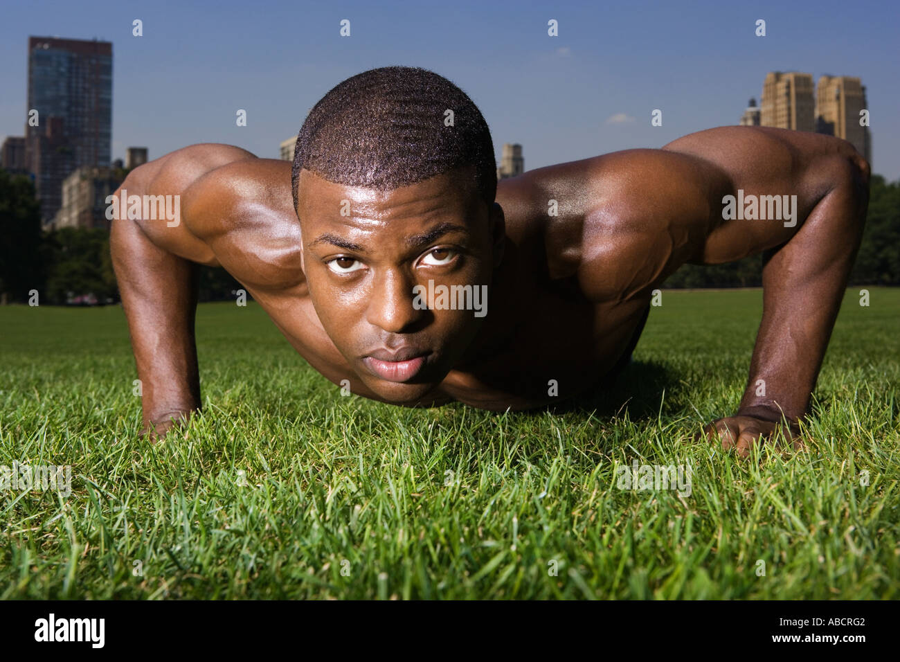 Man doing press ups in the park Stock Photo - Alamy