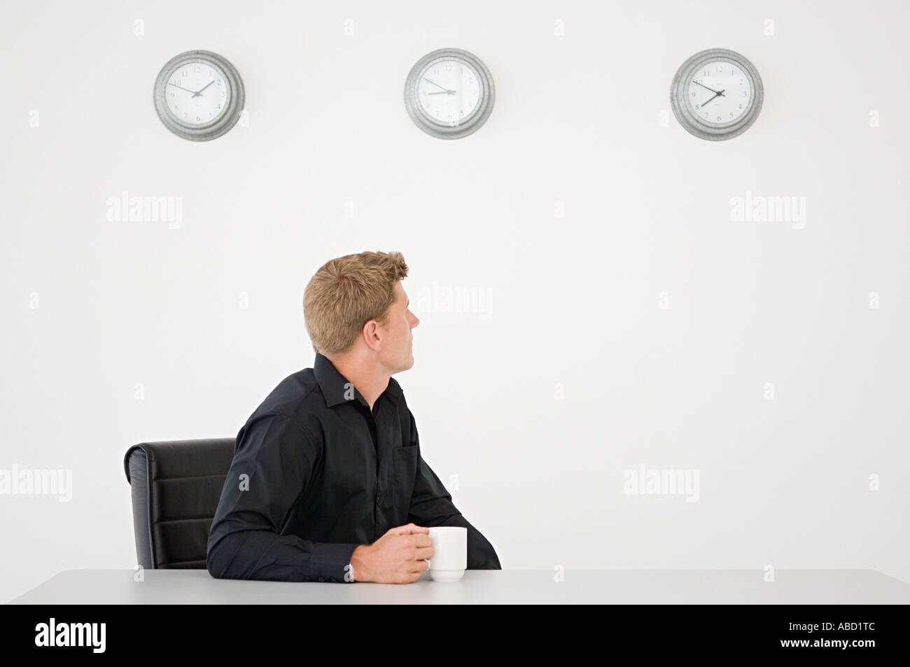 Portrait of a businessman checking time Stock Photo - Alamy