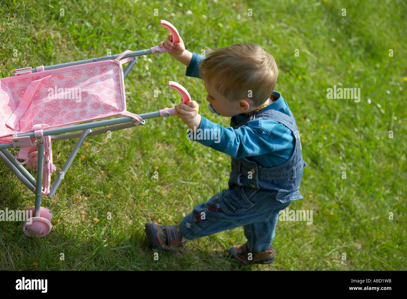 little boy pushing buggy Stock Photo - Alamy