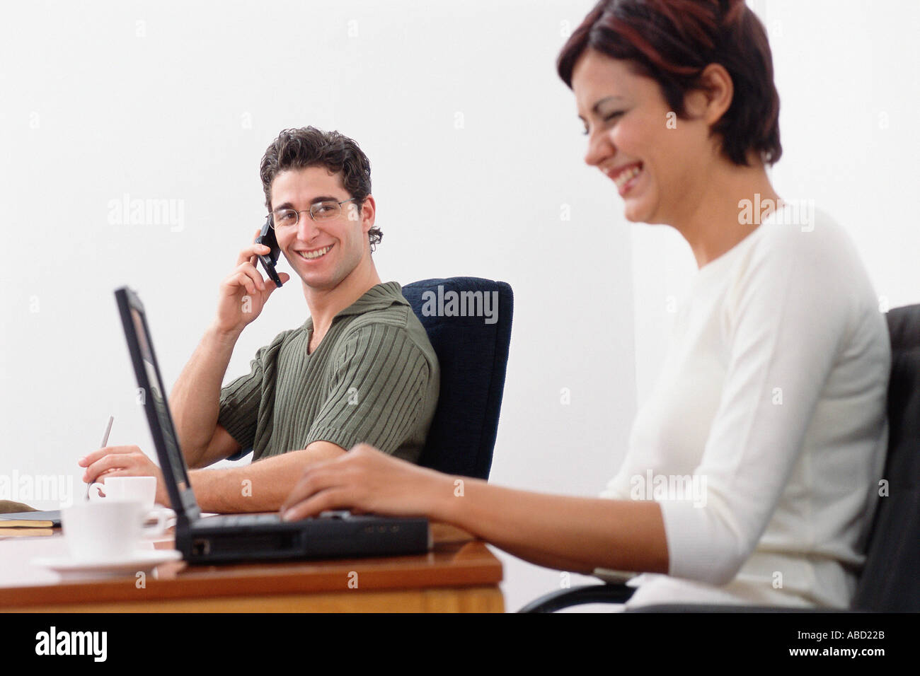 Two laughing businesspeople sitting hi-res stock photography and images ...