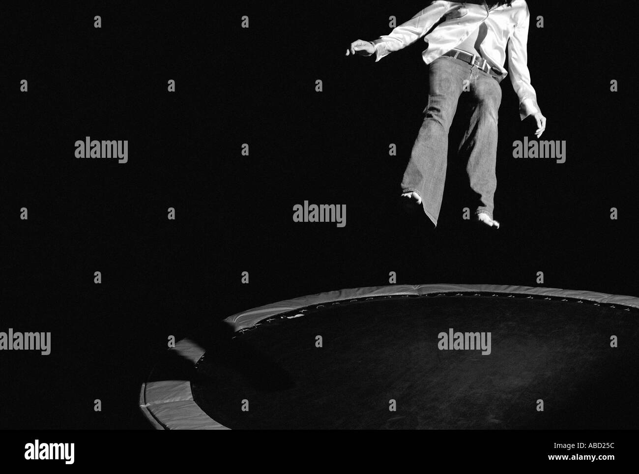 Man jumping on trampoline Stock Photo - Alamy