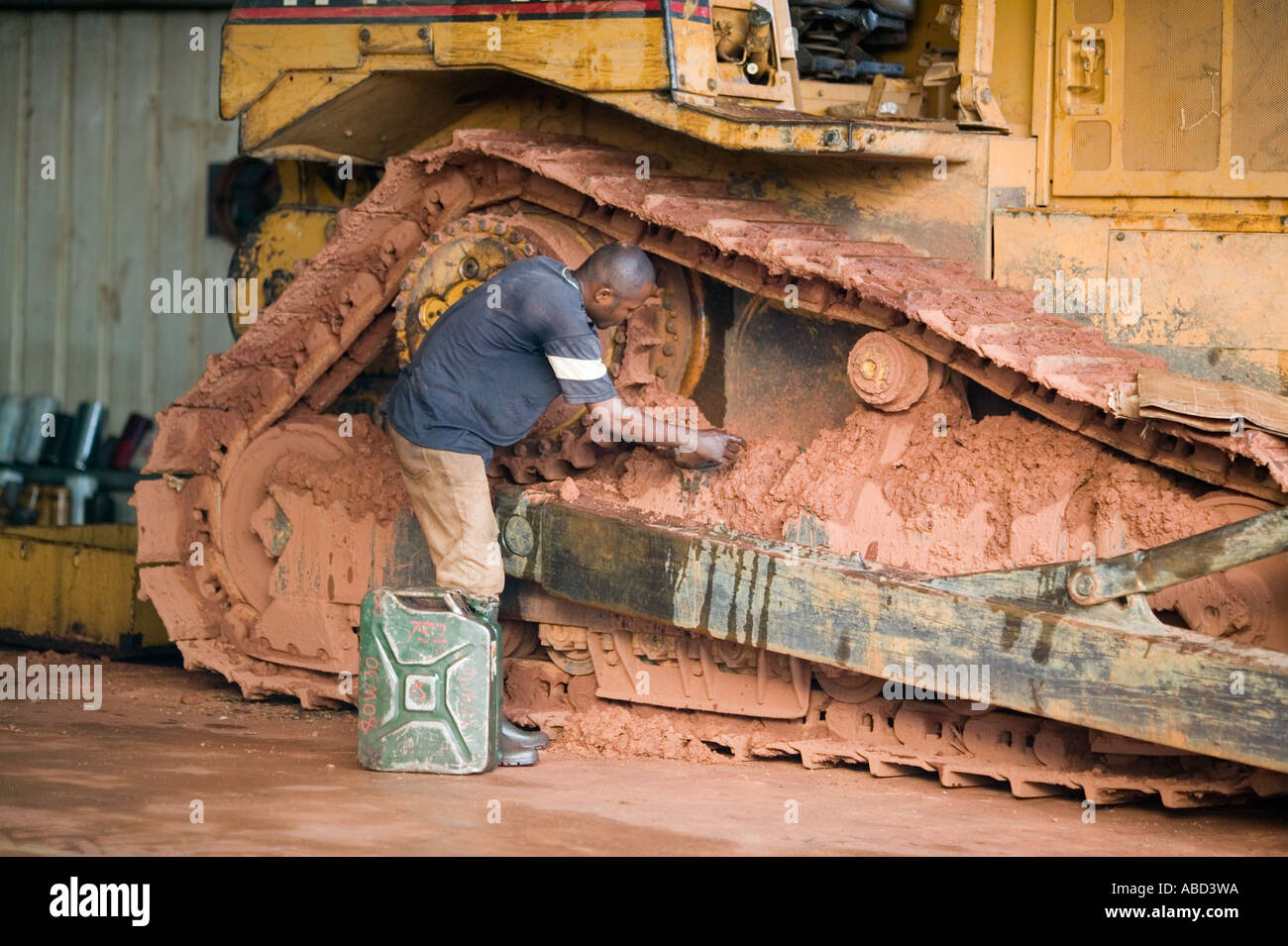 Repairs being made to bulldozer track on logging camp in the rainforest ...