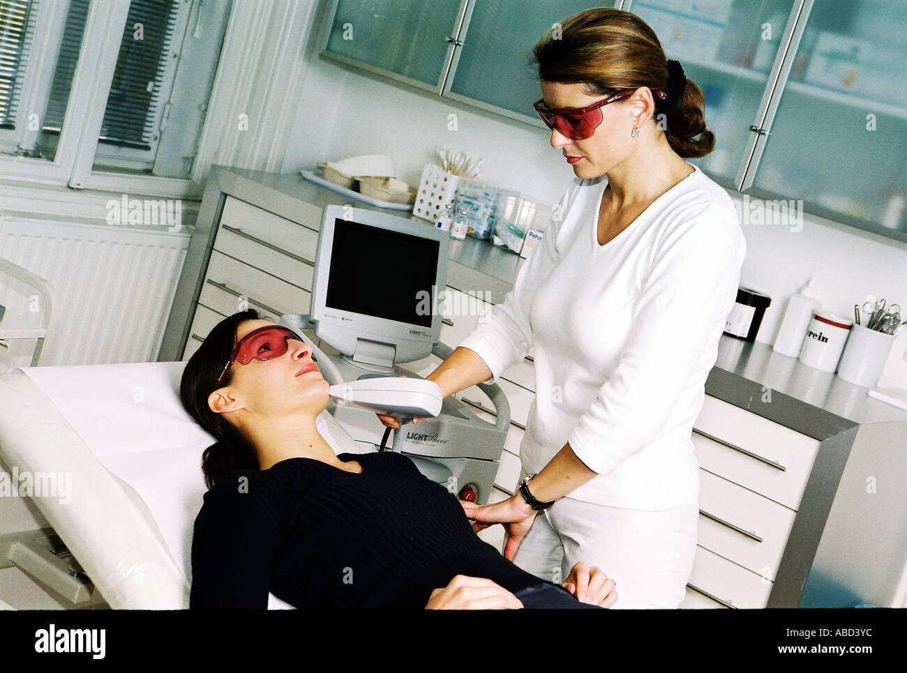 dermatologist removes birth marks by laser Stock Photo - Alamy