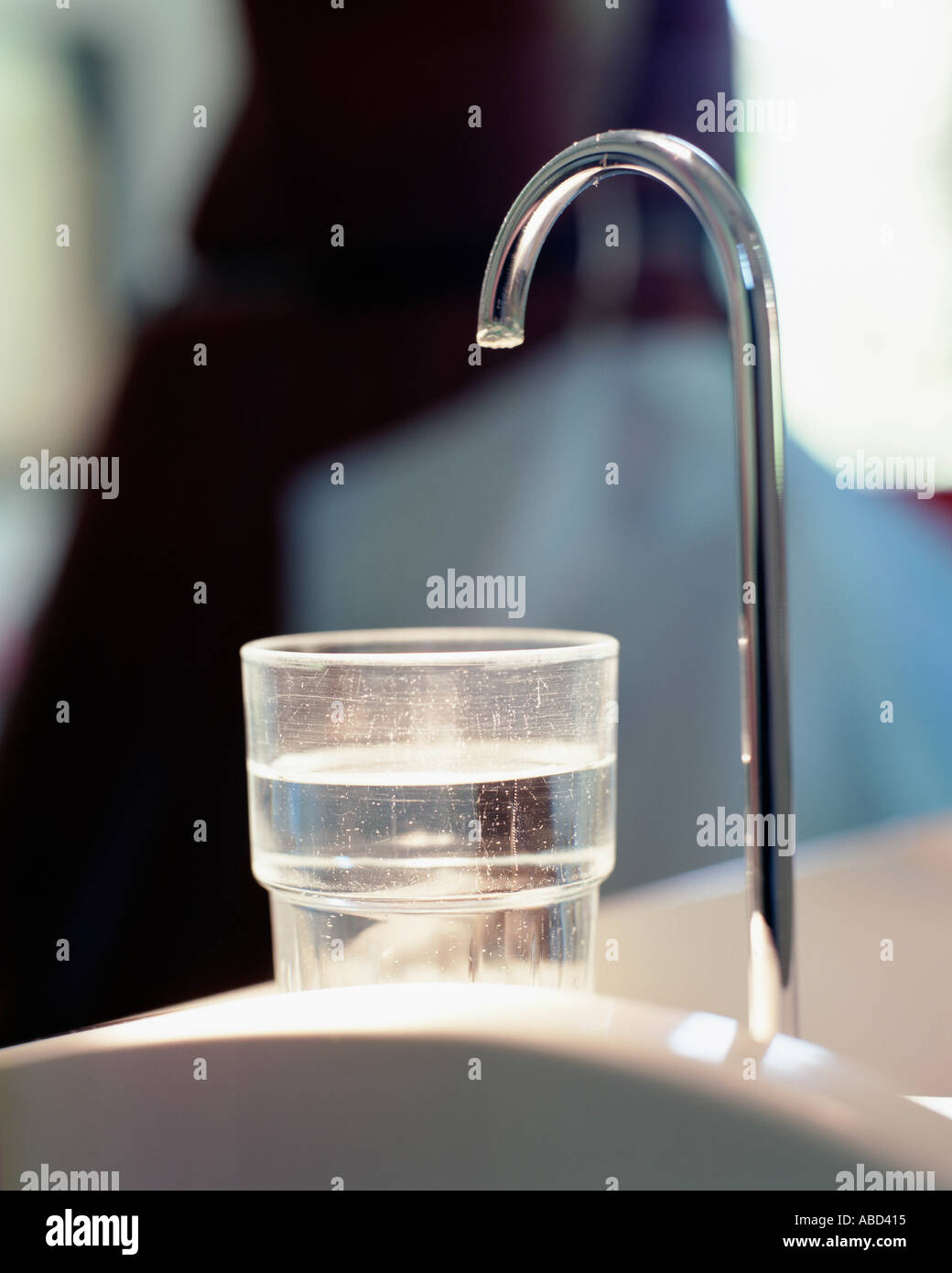 Faucet and water in glass Stock Photo - Alamy