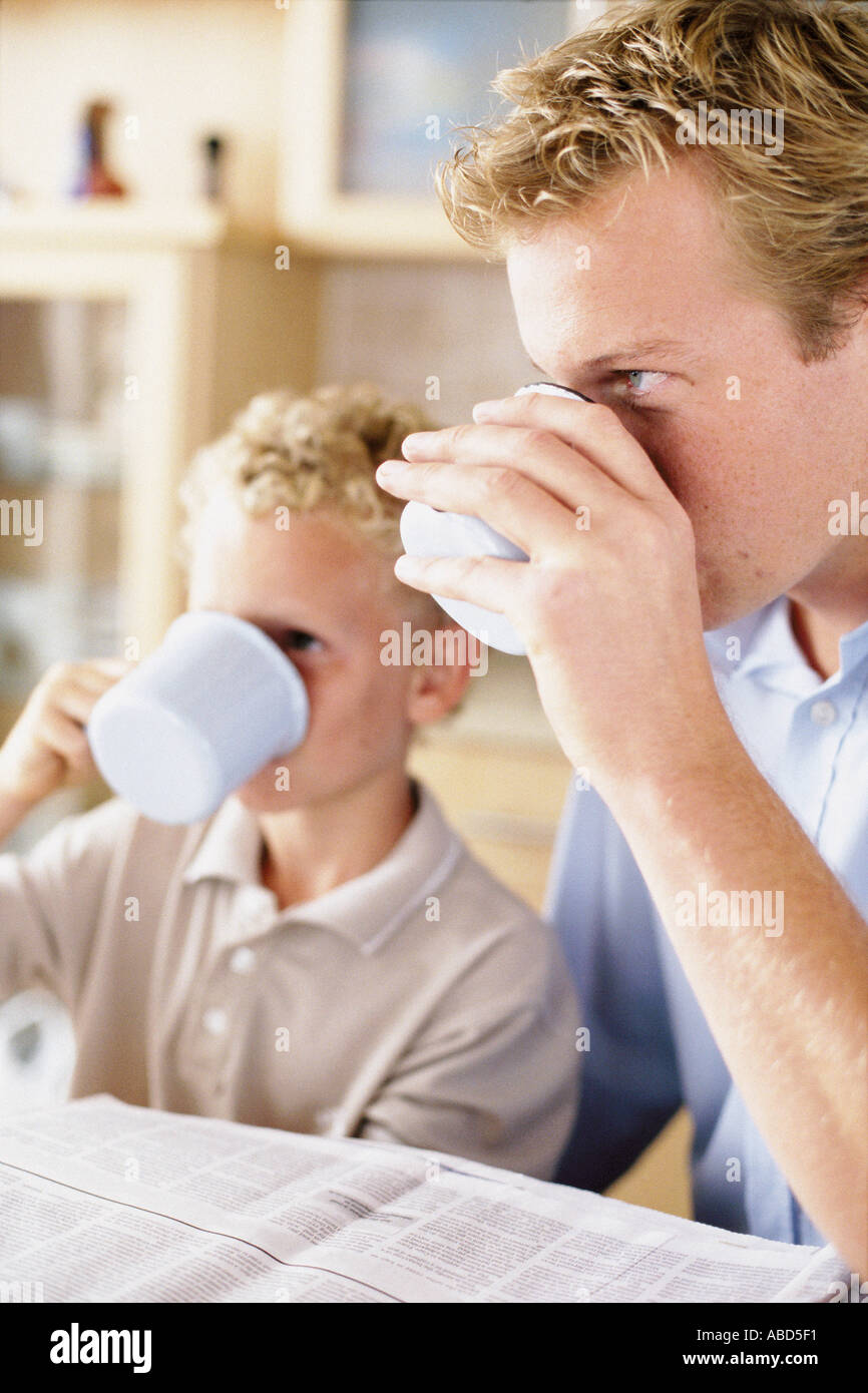 Father and son having a drink Stock Photo - Alamy
