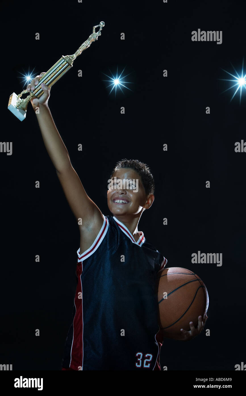 Boy holding up a basketball trophy Stock Photo - Alamy