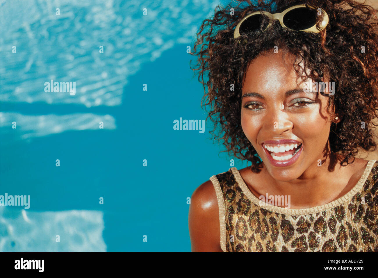 Young woman smiling by the pool Stock Photo - Alamy