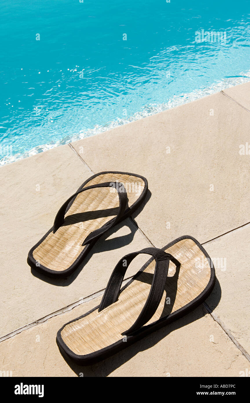 Flip flops by the pool Stock Photo - Alamy
