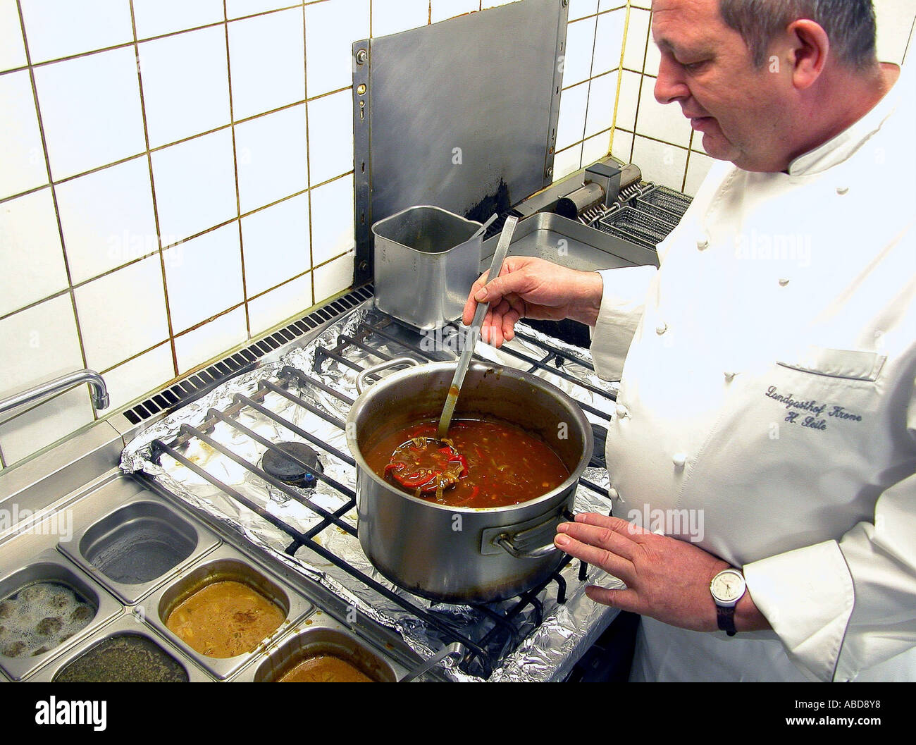 Cook making a soup Stock Photo - Alamy