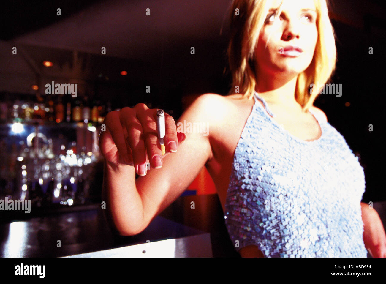 Woman smoking in nightclub Stock Photo - Alamy