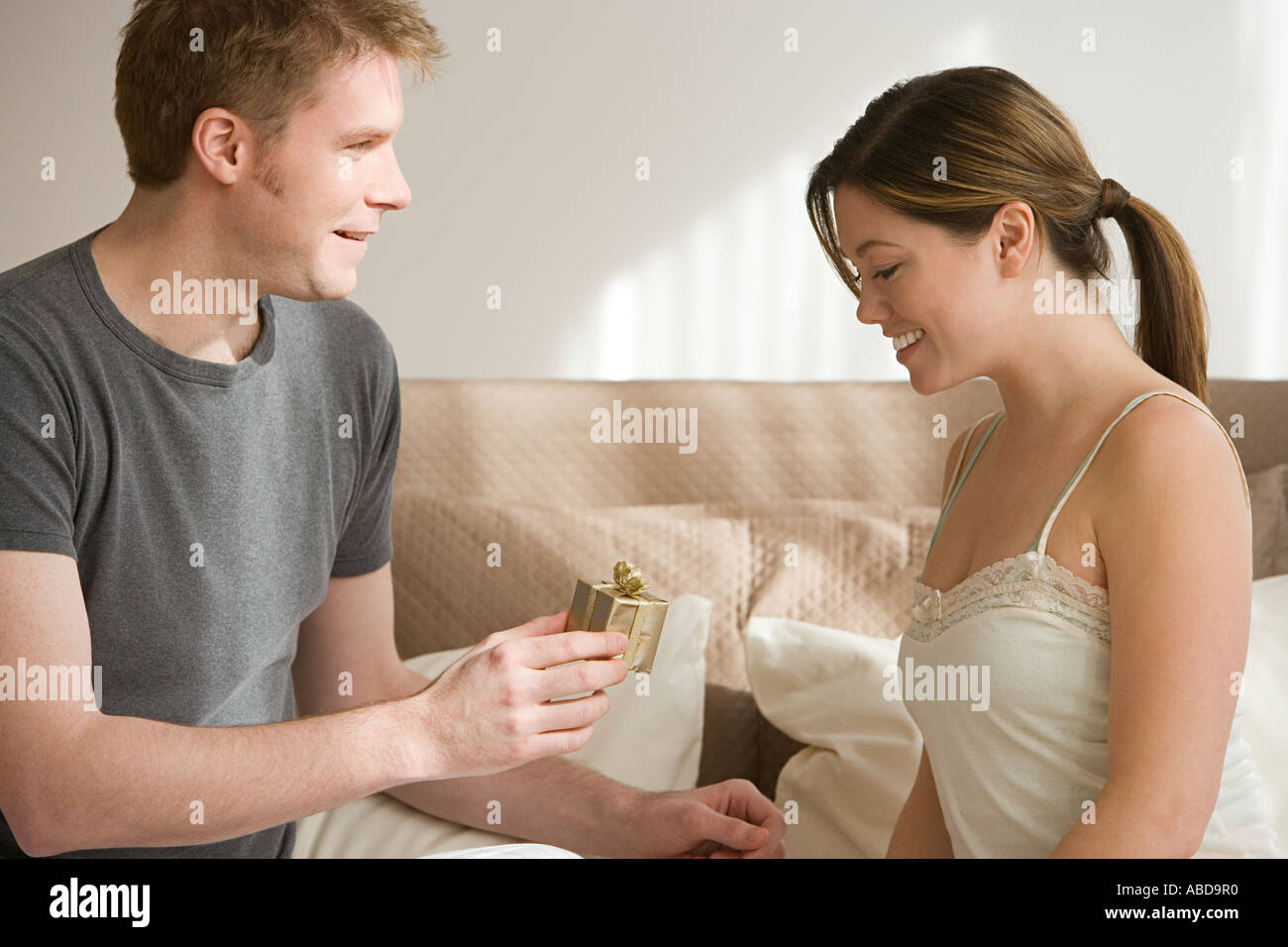 Man giving gift to woman Stock Photo - Alamy