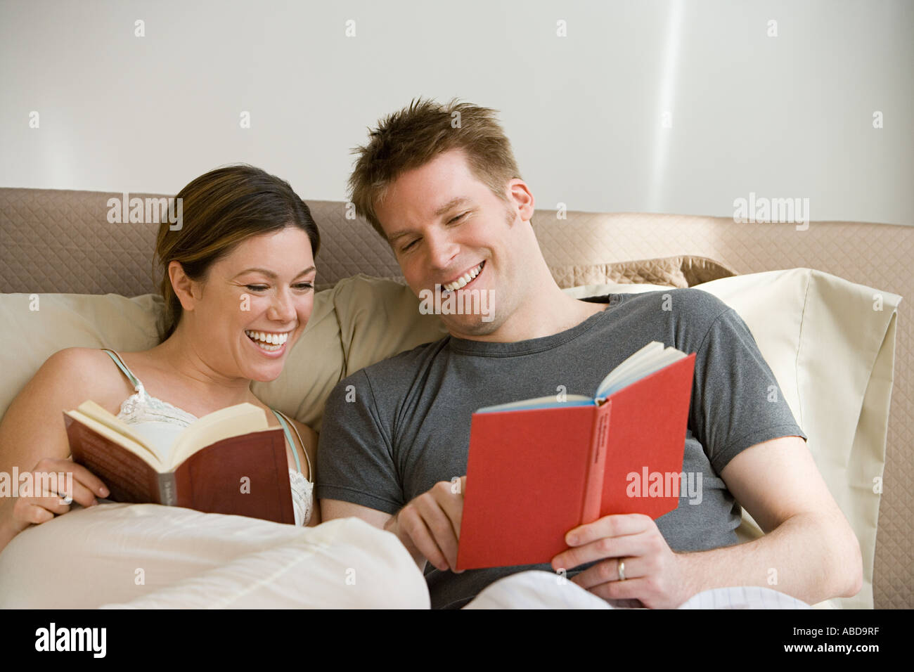 Couple reading in bed Stock Photo - Alamy