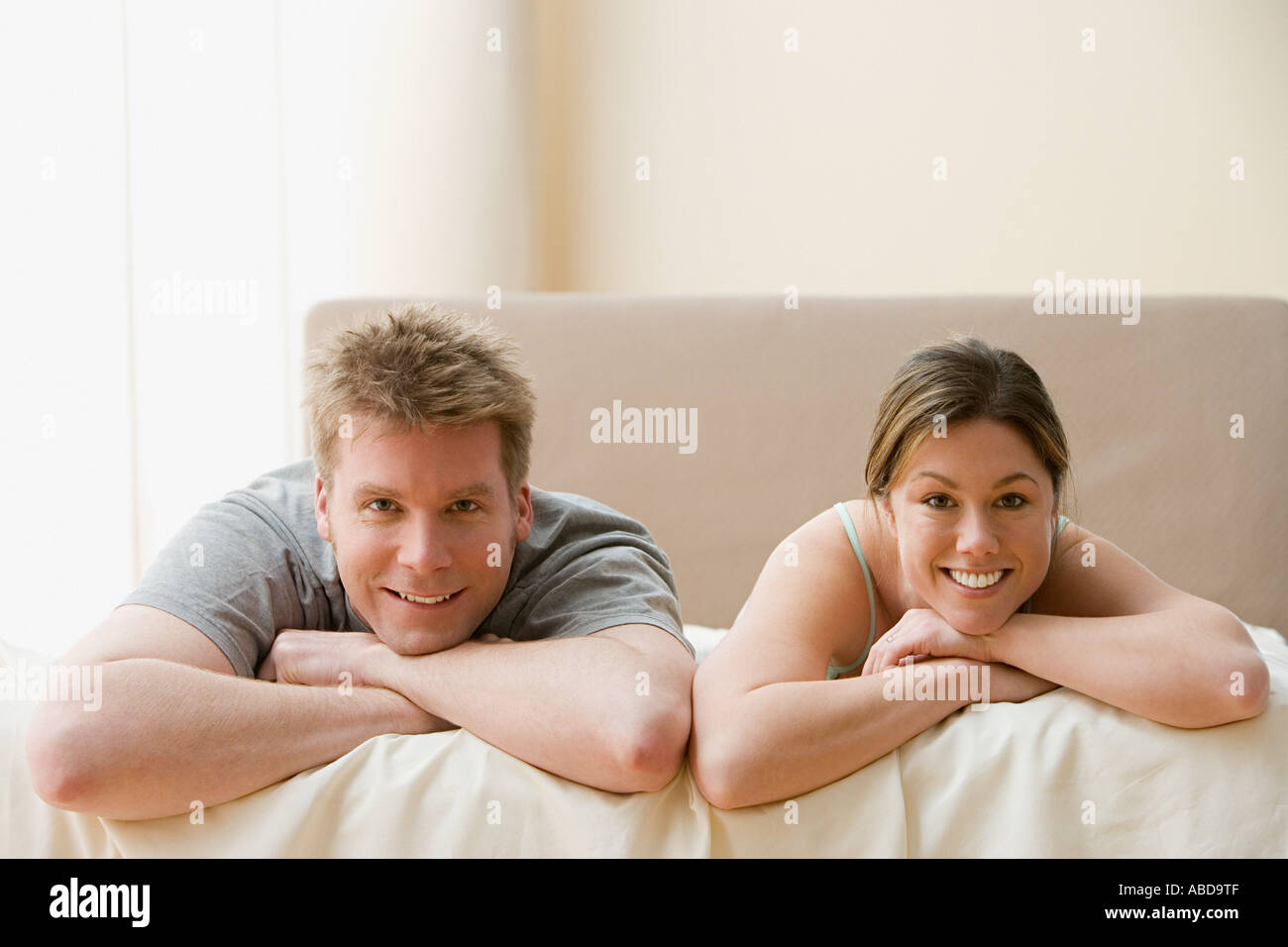 Couple lying on bed Stock Photo - Alamy