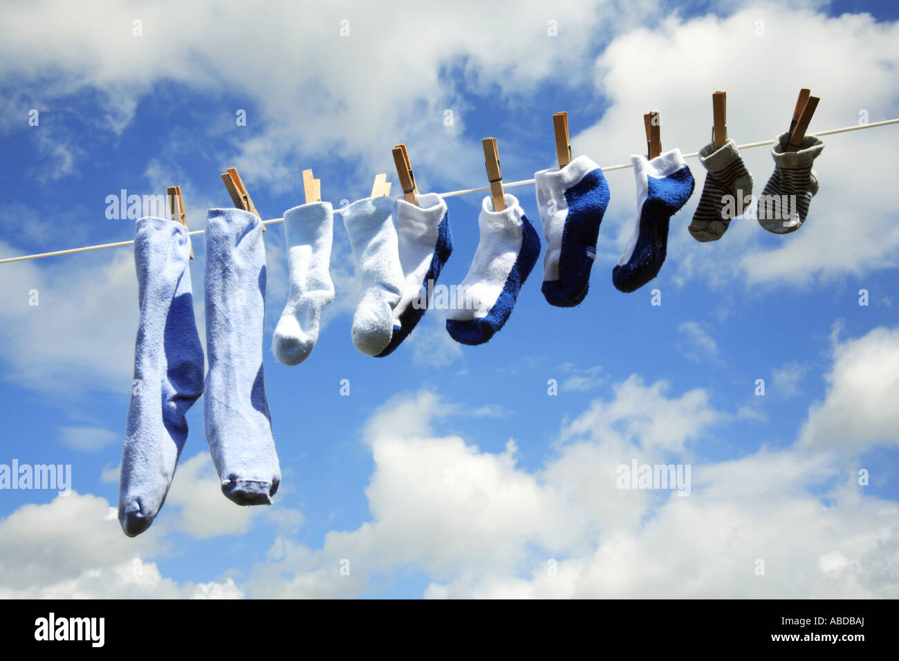 A row of freshly washed socks of assorted sizes on a linen line Stock ...