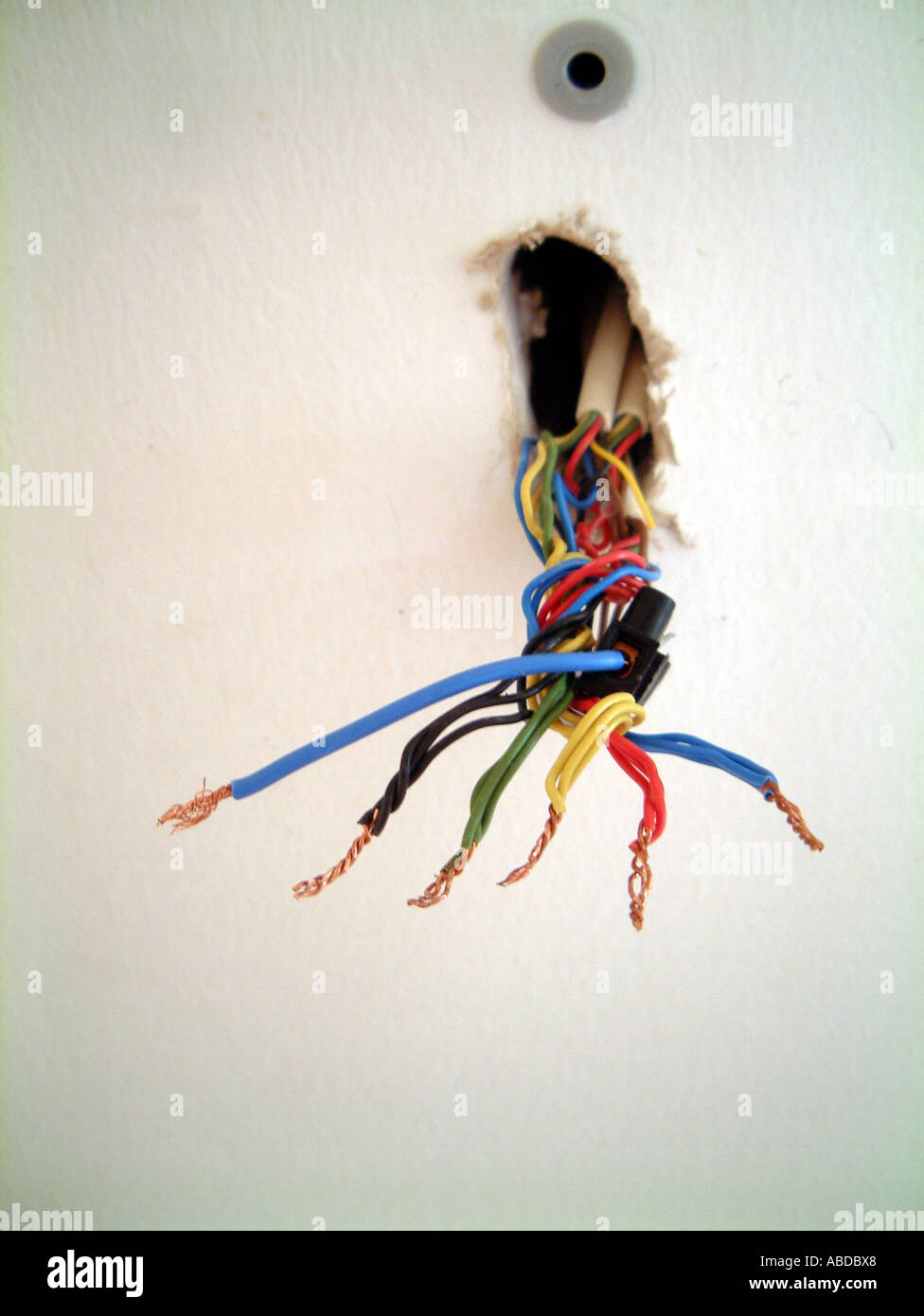Electrical wire standing out from a wall Stock Photo - Alamy