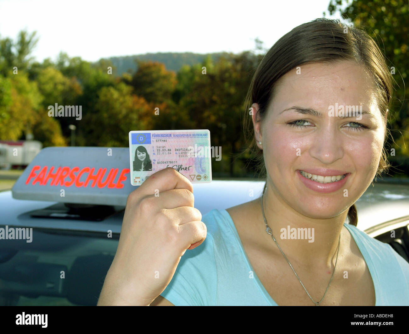 Young woman showing proudly her new driving licence Stock Photo - Alamy