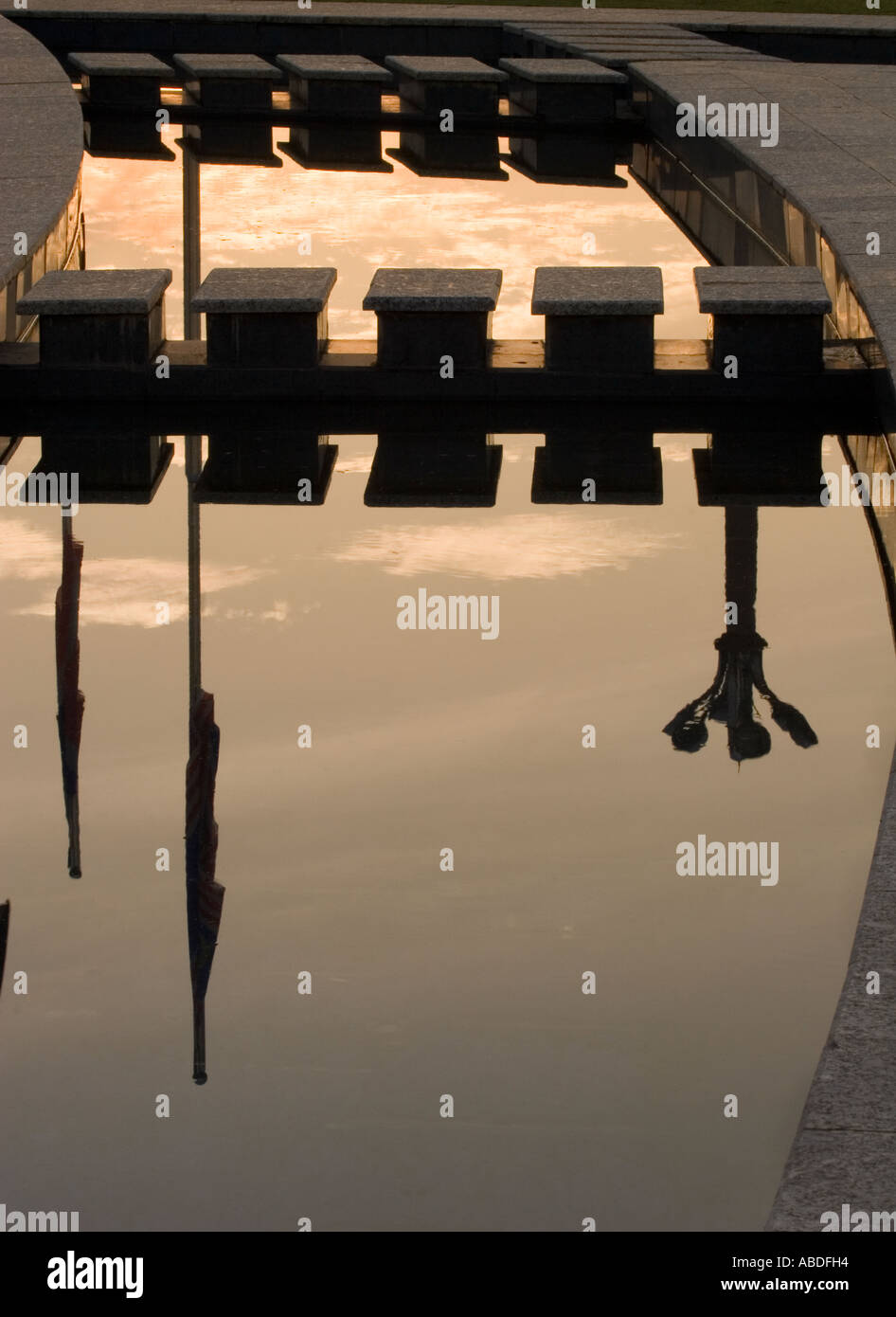 Reflection of flags in a pool at sunrise, Putra Mosque, Putrajaya ...