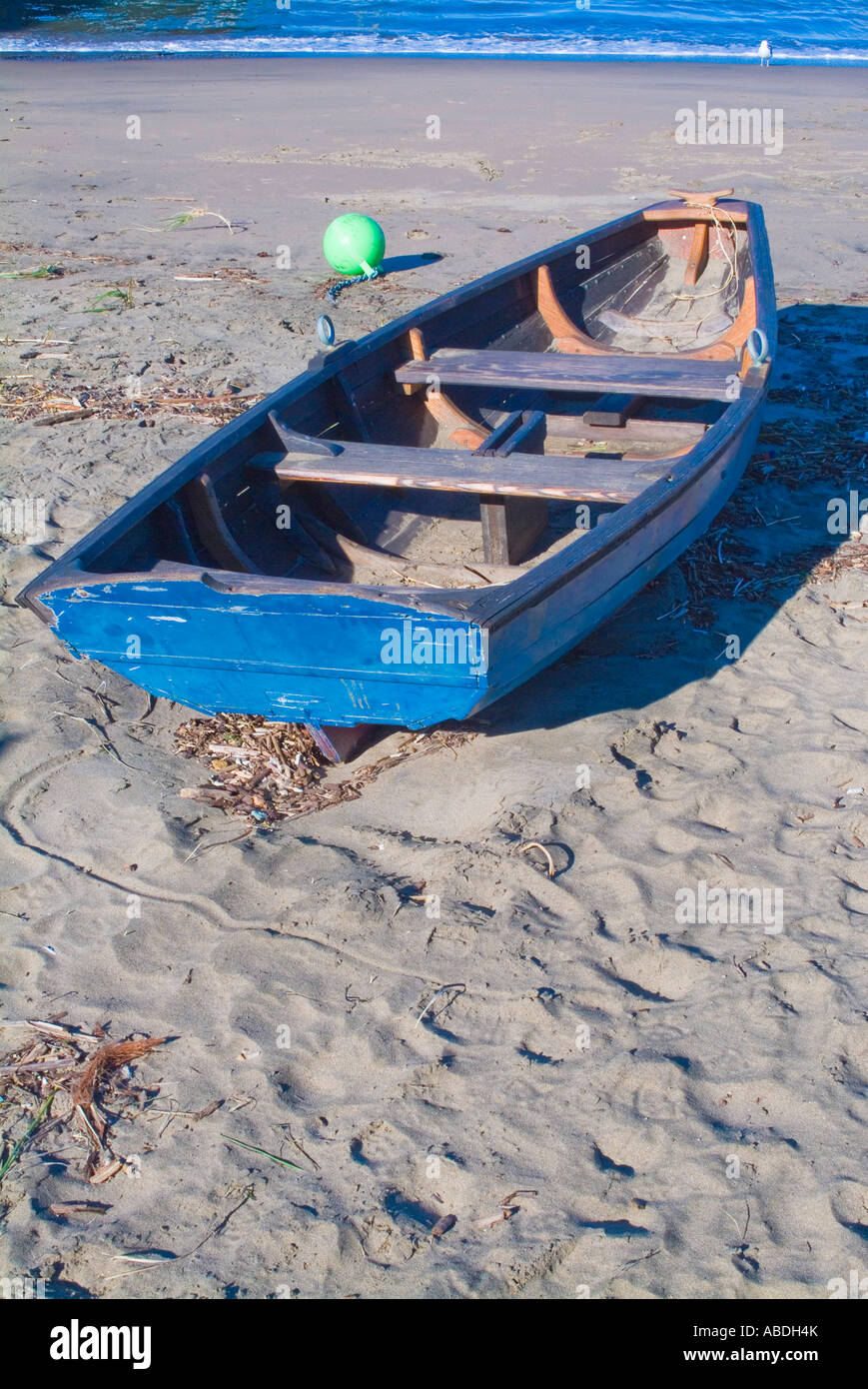 Blue wooden rowboat on isolated beach Stock Photo - Alamy