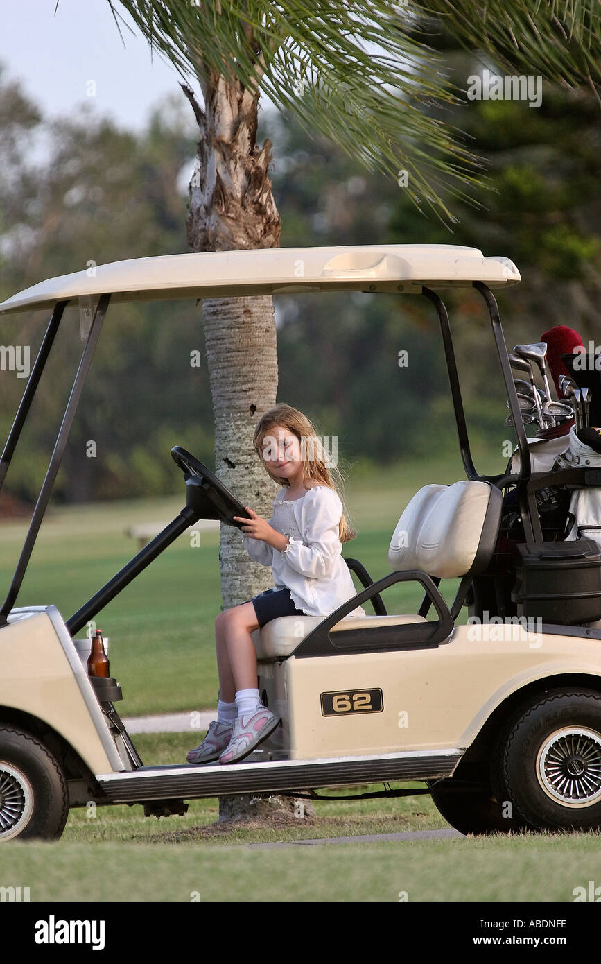 Little girl learning to drive golf cart in scenic Florida USA Stock ...