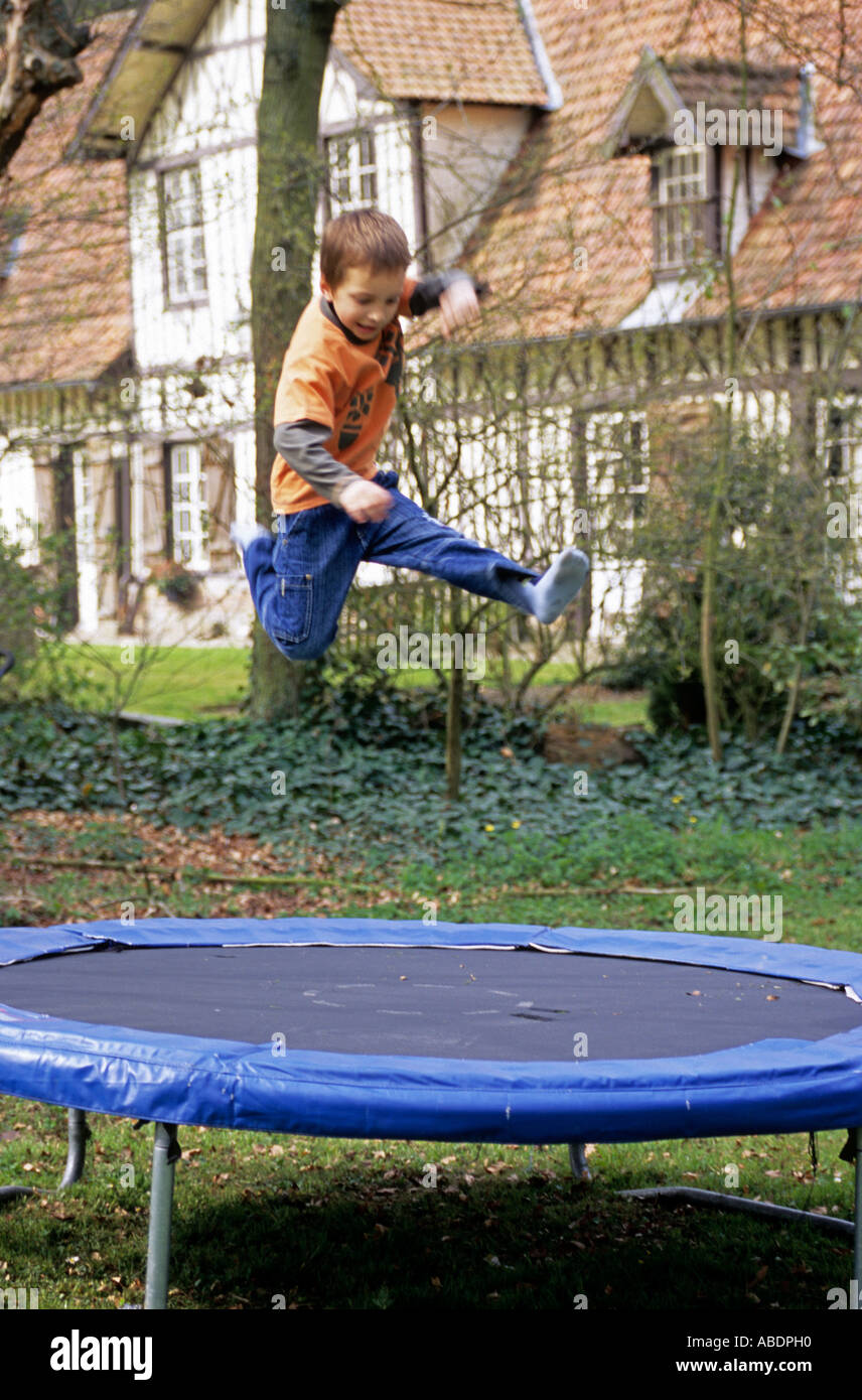 Normandy boy jumping on spring board Stock Photo - Alamy