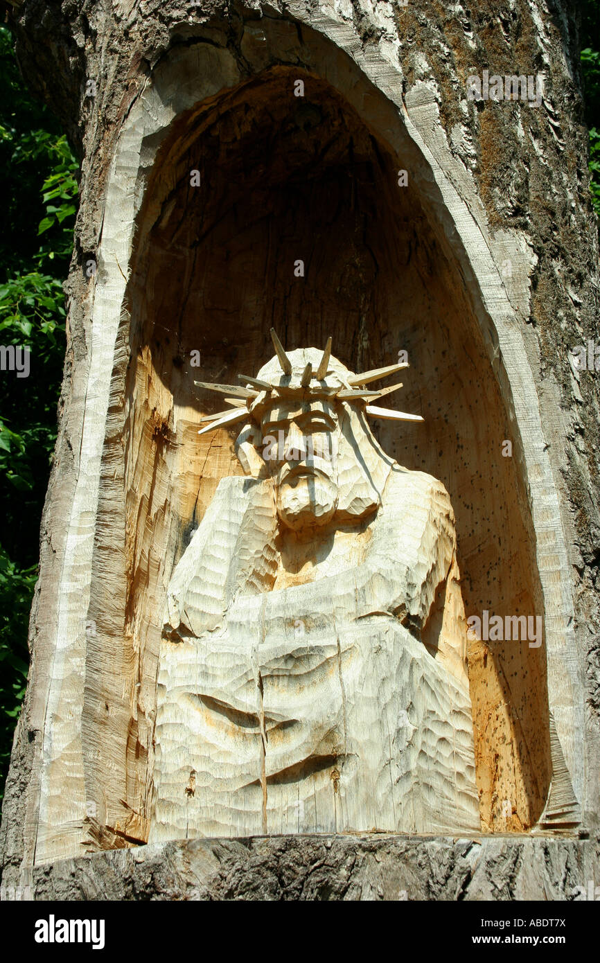 Jesus figure carved in a tree Stock Photo - Alamy