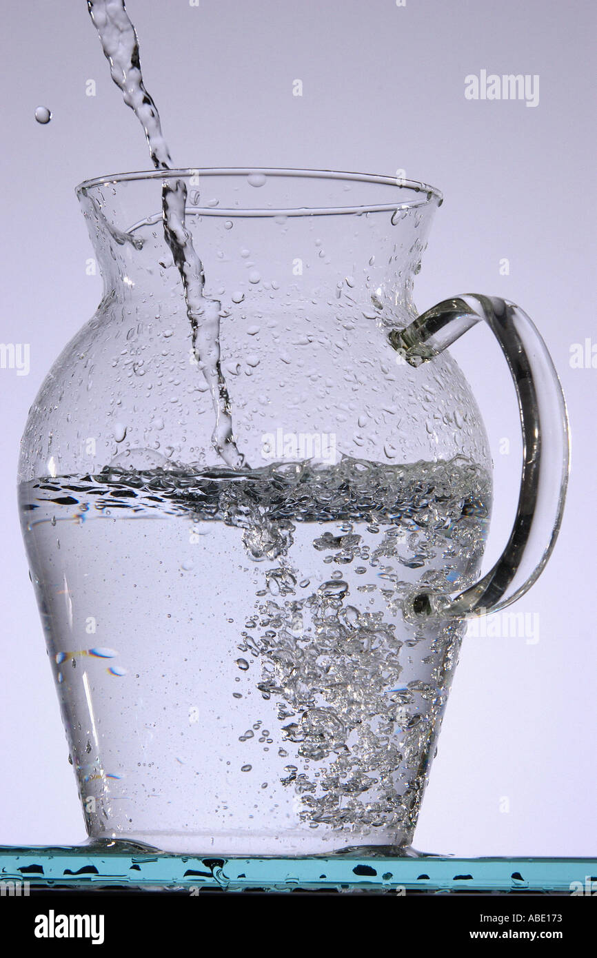 Water pouring into jug Stock Photo - Alamy