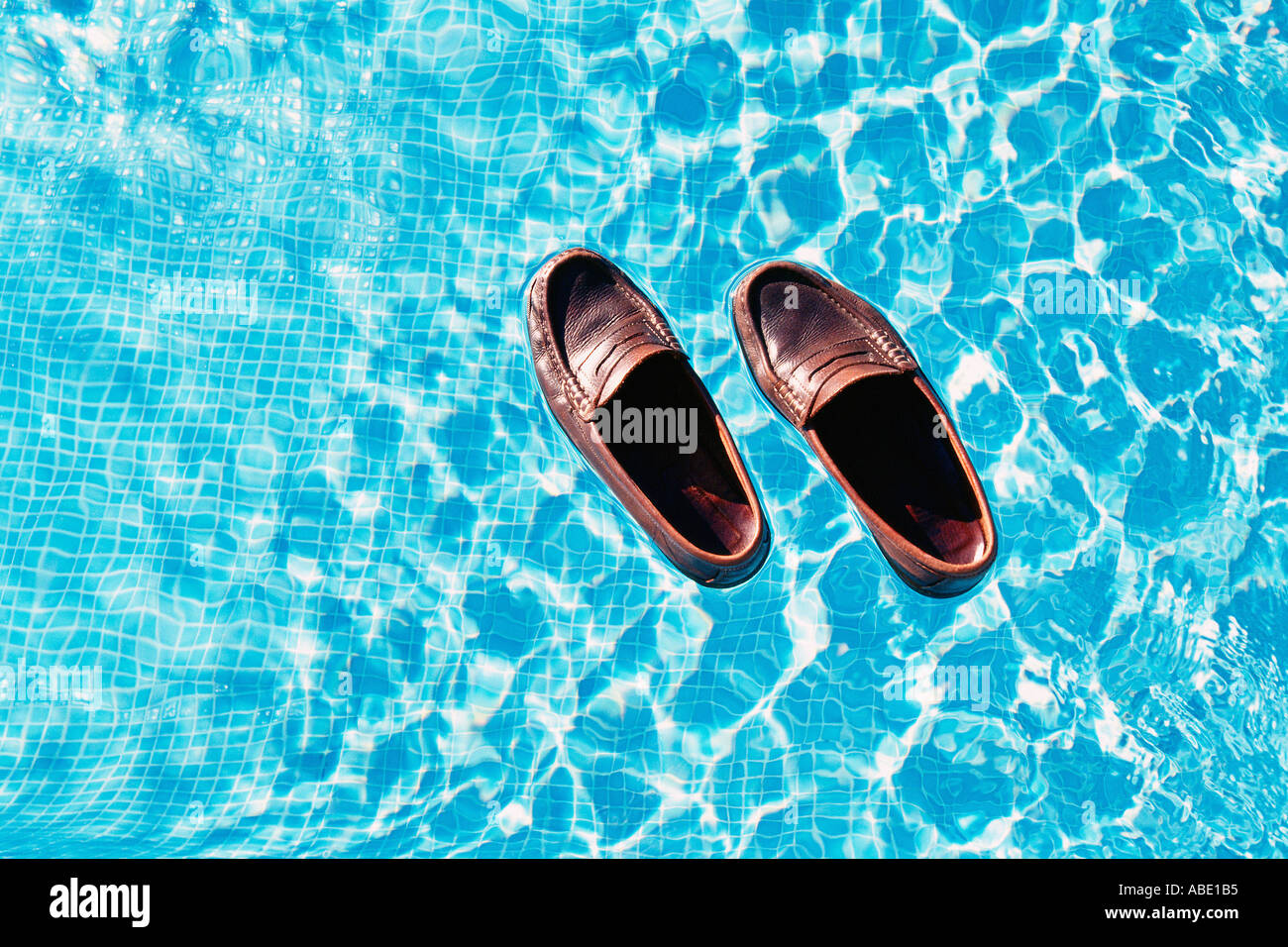 Shoes floating in swimming pool Stock Photo - Alamy