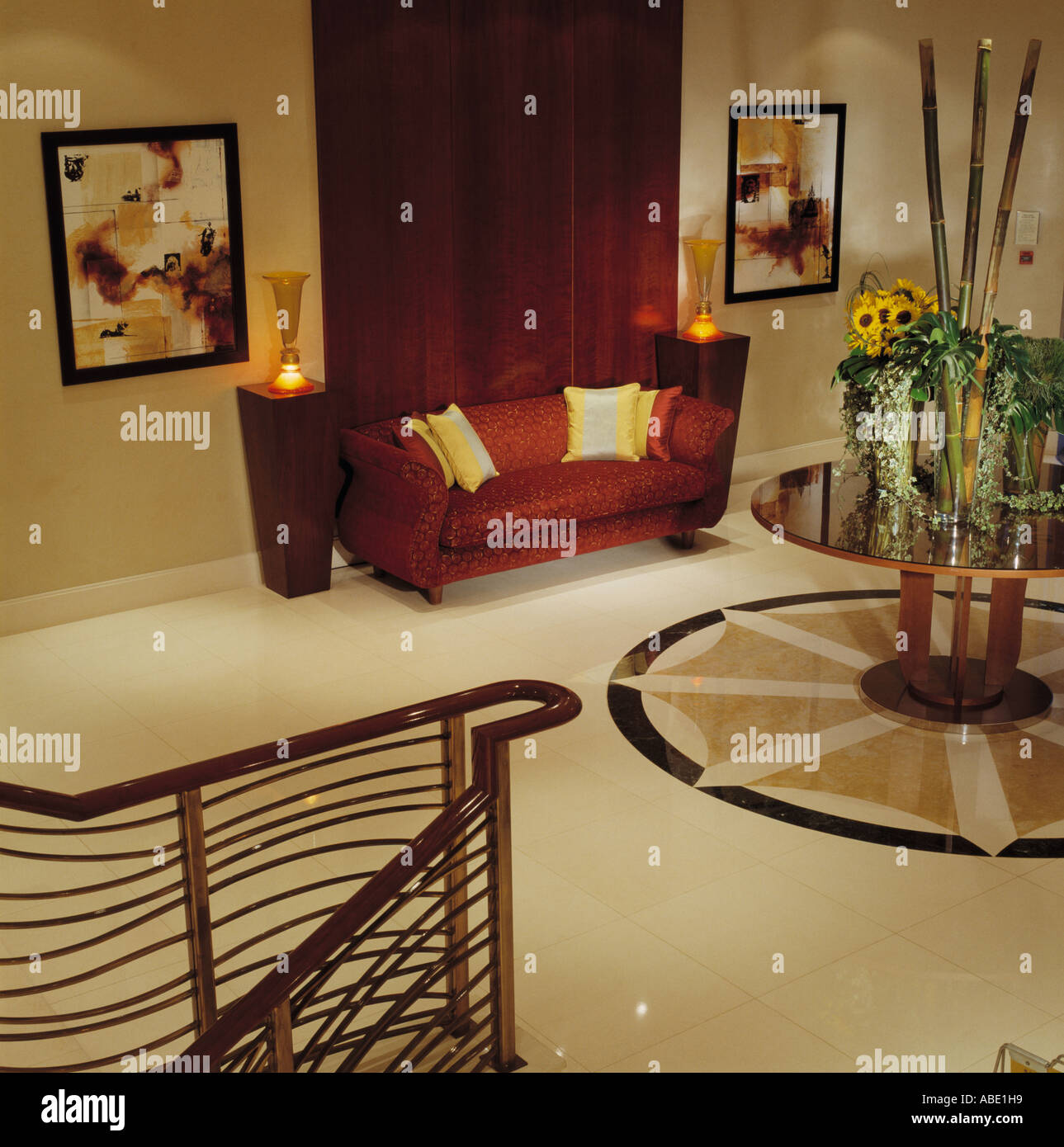 Red sofa and inlaid flooring in hotel lobby with large floral ...