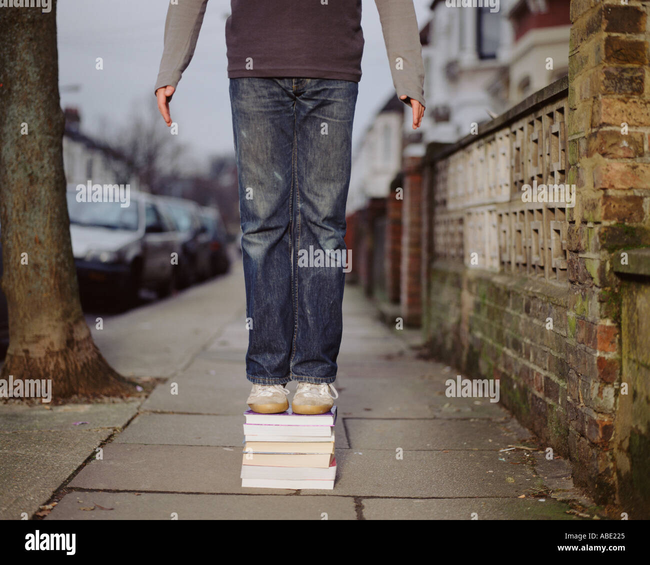 Standing man on book pile hi-res stock photography and images - Alamy