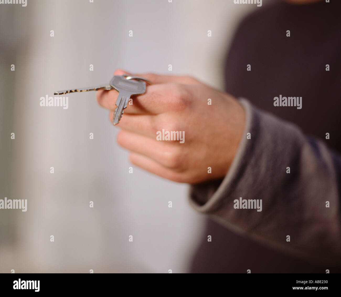 Young man holding keys Stock Photo - Alamy