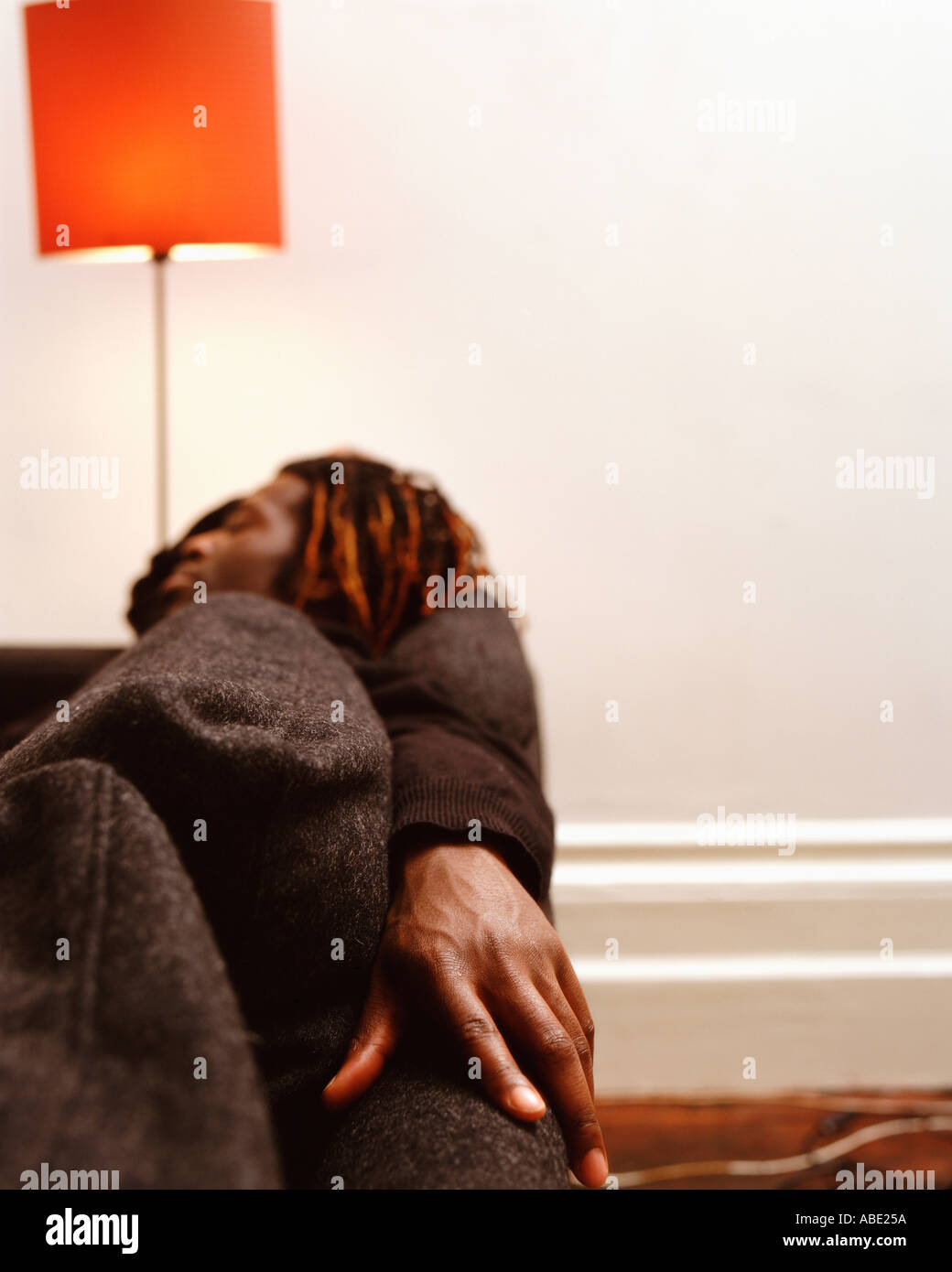 African man sleeping on sofa hi-res stock photography and images - Alamy
