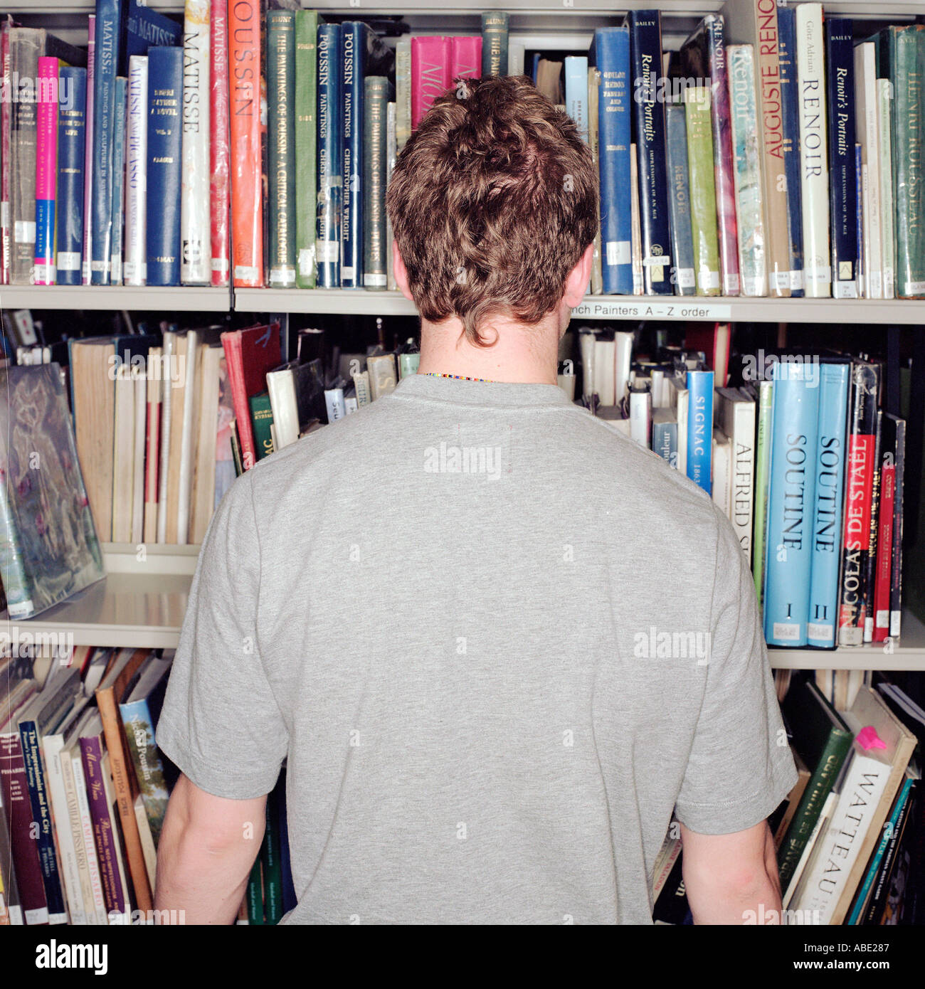 Man choosing a book Stock Photo - Alamy