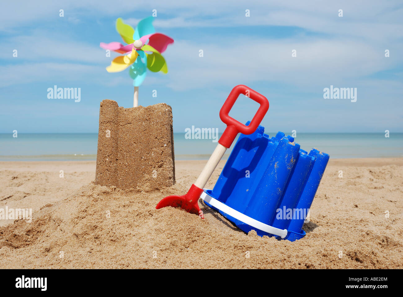 sandcastle spade bucket and windmill on beach kent Stock Photo - Alamy