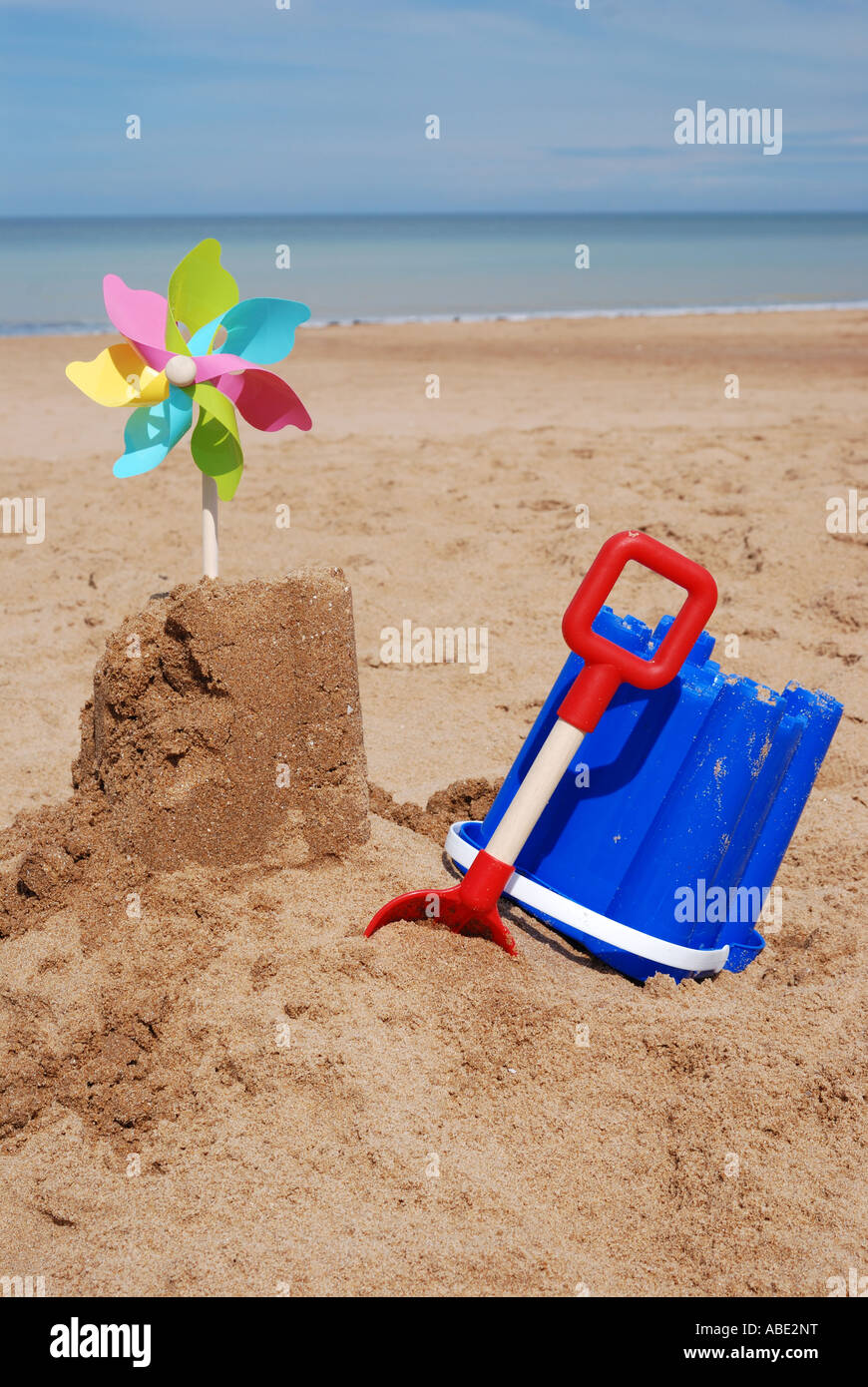 sandcastle spade bucket and windmill on beach kent Stock Photo - Alamy