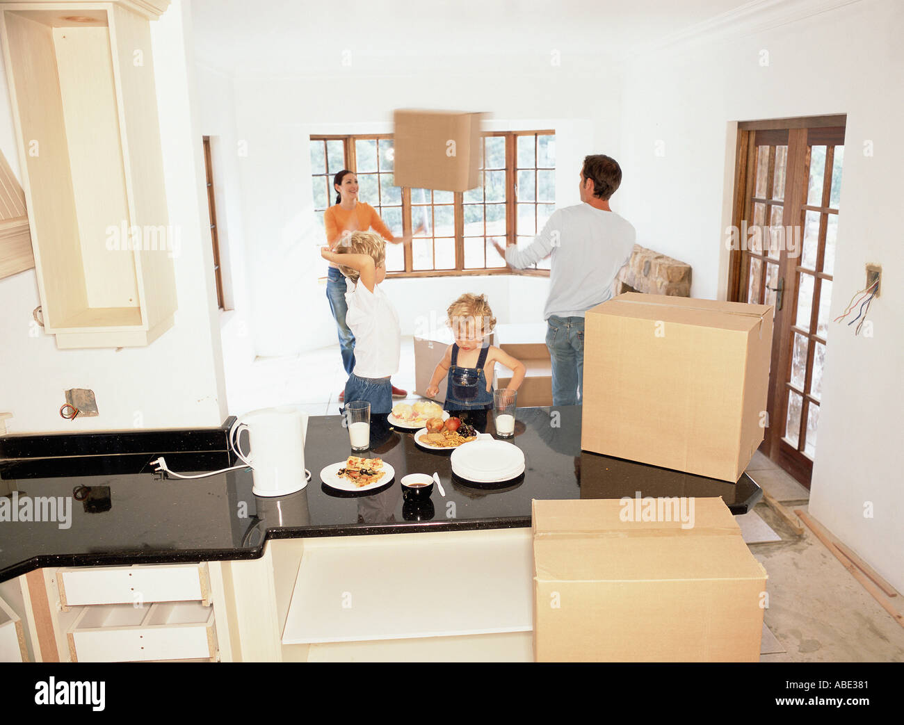 Happy family in new home Stock Photo - Alamy
