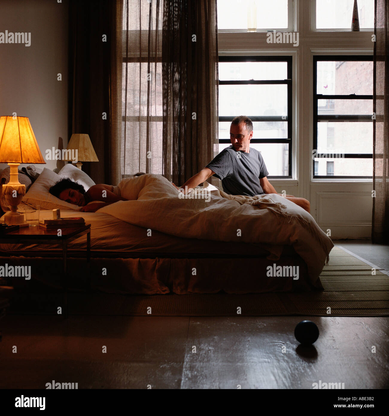 Couple resting on bed Stock Photo - Alamy
