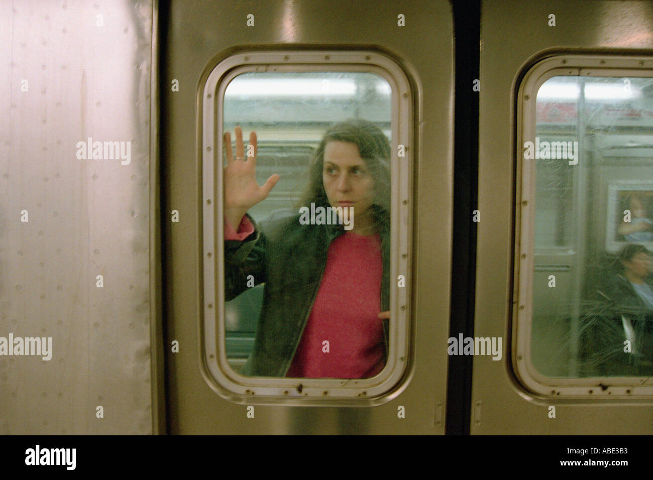 Female commuter on subway train Stock Photo - Alamy
